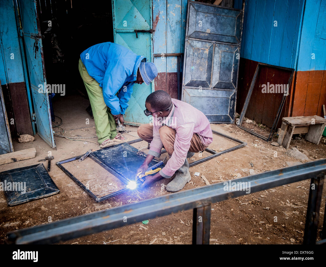 Welder in Kenya, Africa welds steel frames for doors and windows Stock ...