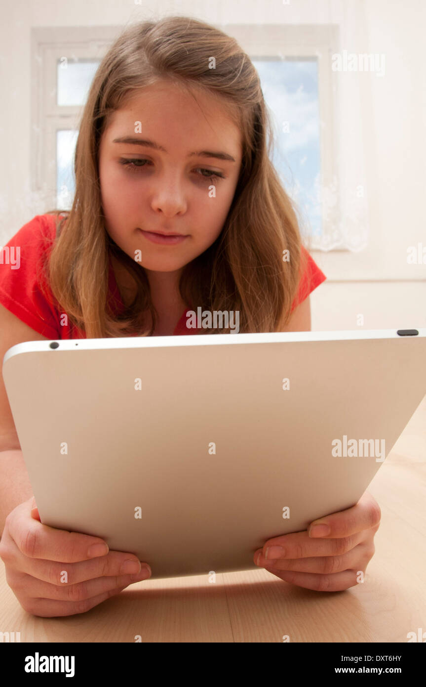 girl reading on a tablet Stock Photo - Alamy