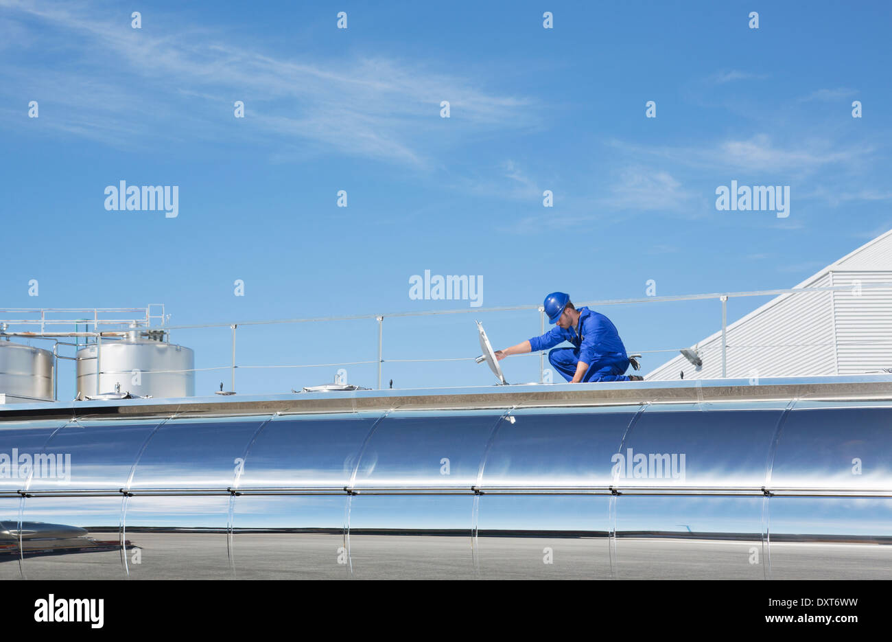 Worker on platform above stainless steel milk tanker Stock Photo - Alamy