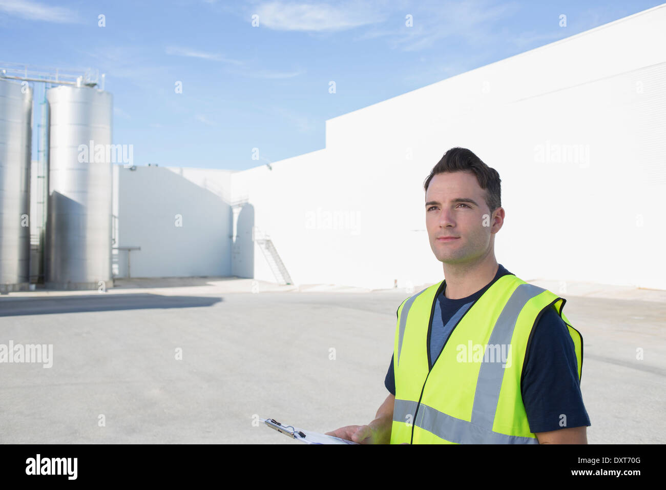 Worker with clipboard at granary Stock Photo - Alamy