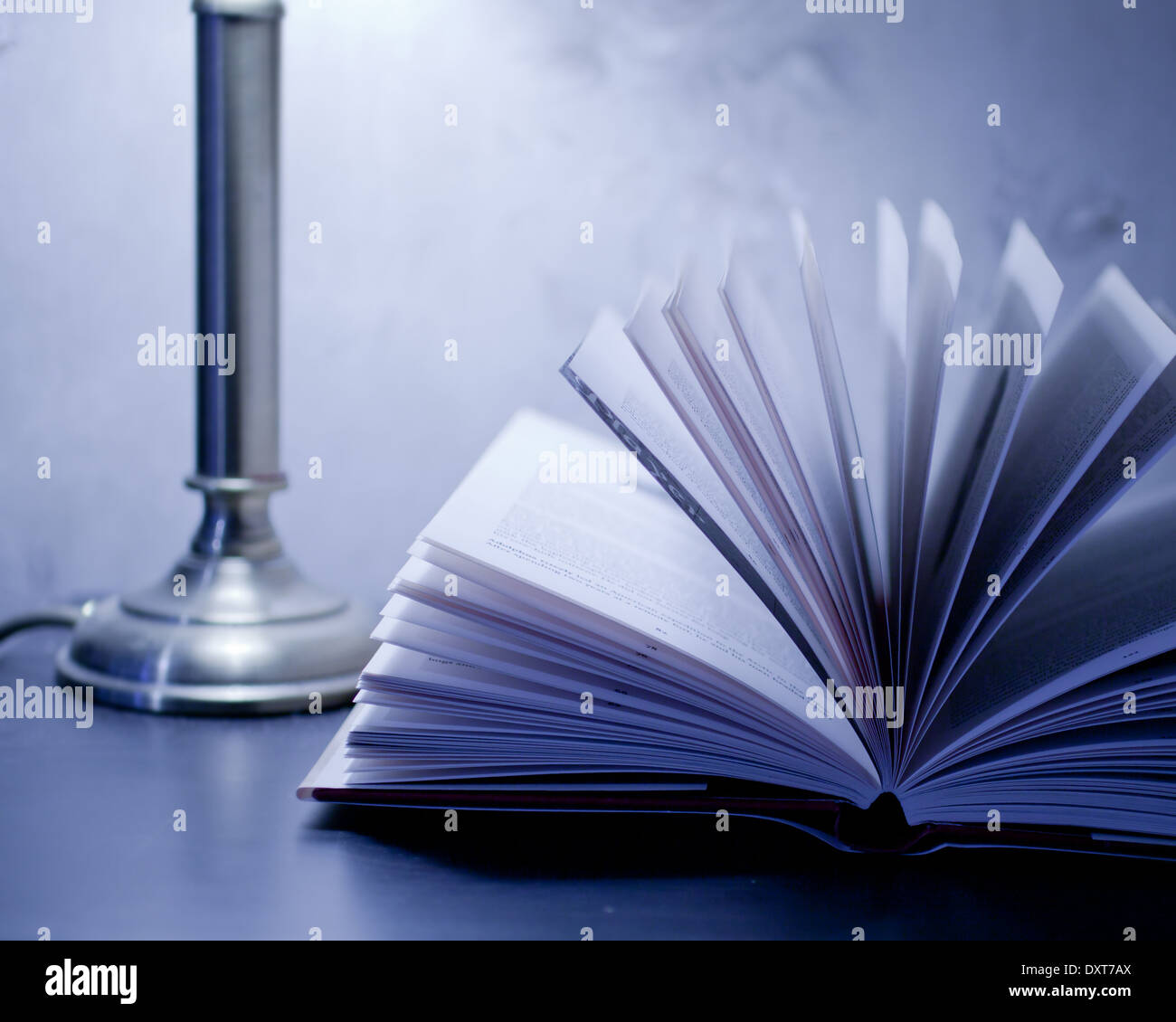 Open book on a bedside table Stock Photo - Alamy