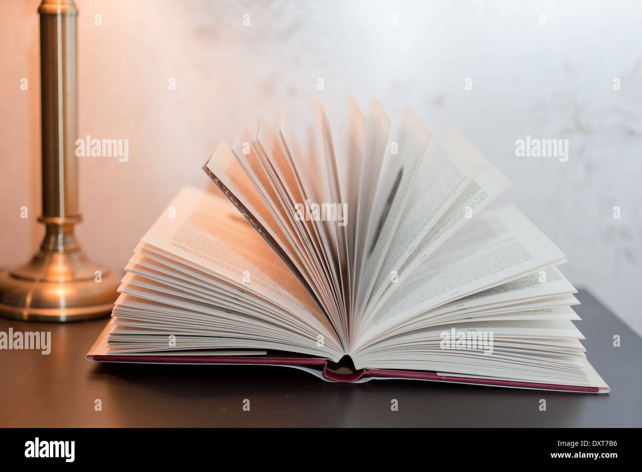 Open book on a bedside table Stock Photo - Alamy