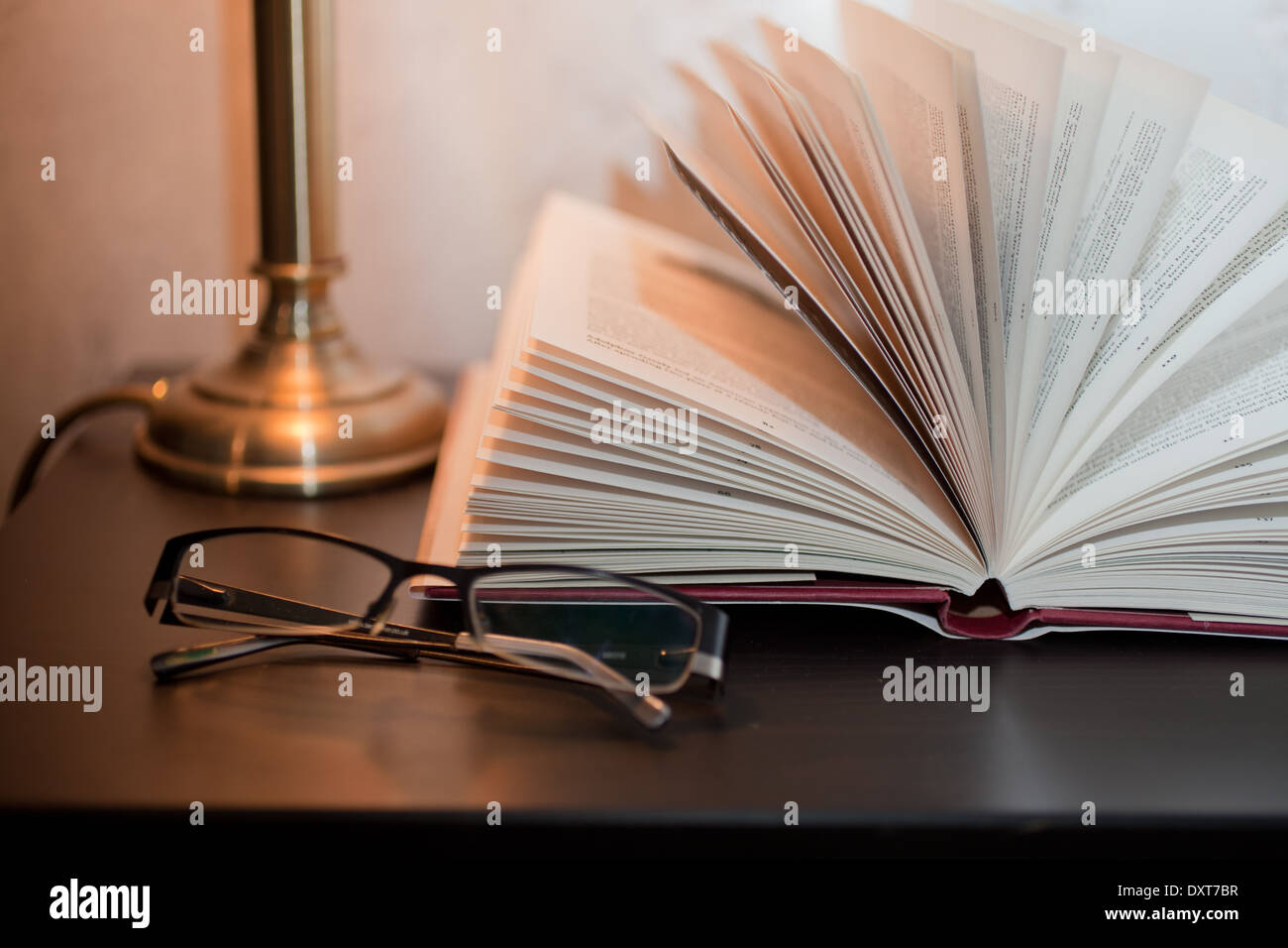 Open book on a bedside table Stock Photo - Alamy