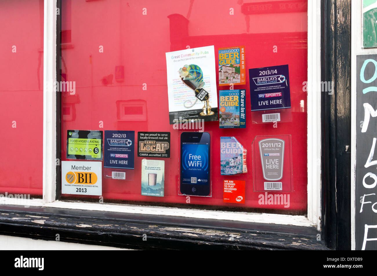 Old stickers in UK pub window Stock Photo - Alamy