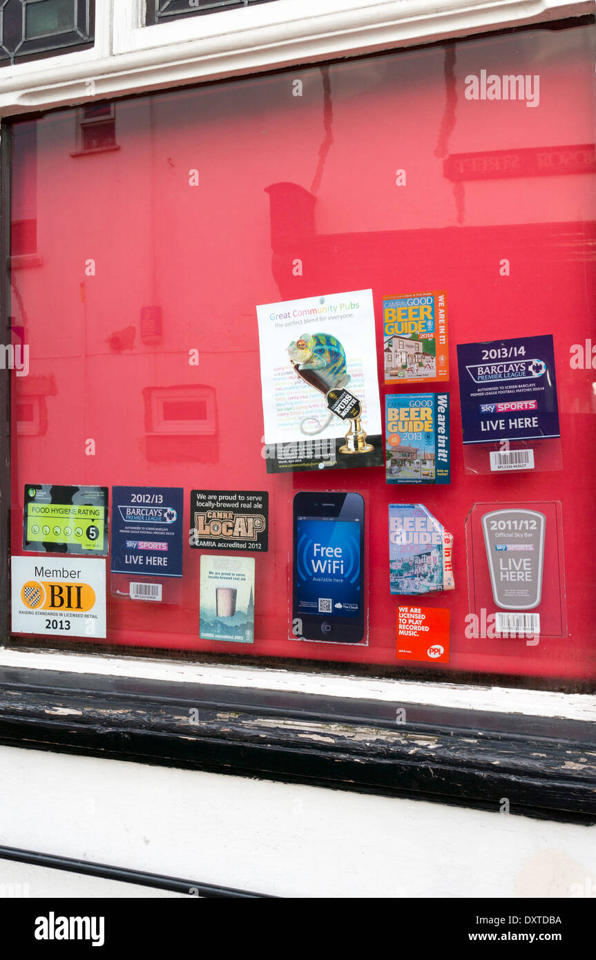 Old stickers in UK pub window Stock Photo - Alamy