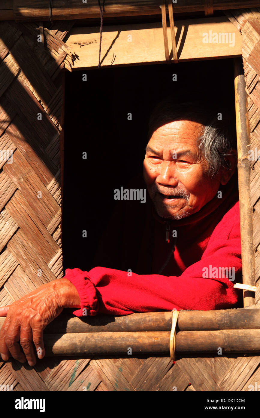 A man from the Bawm tribe looks out of a hut window in the village of ...