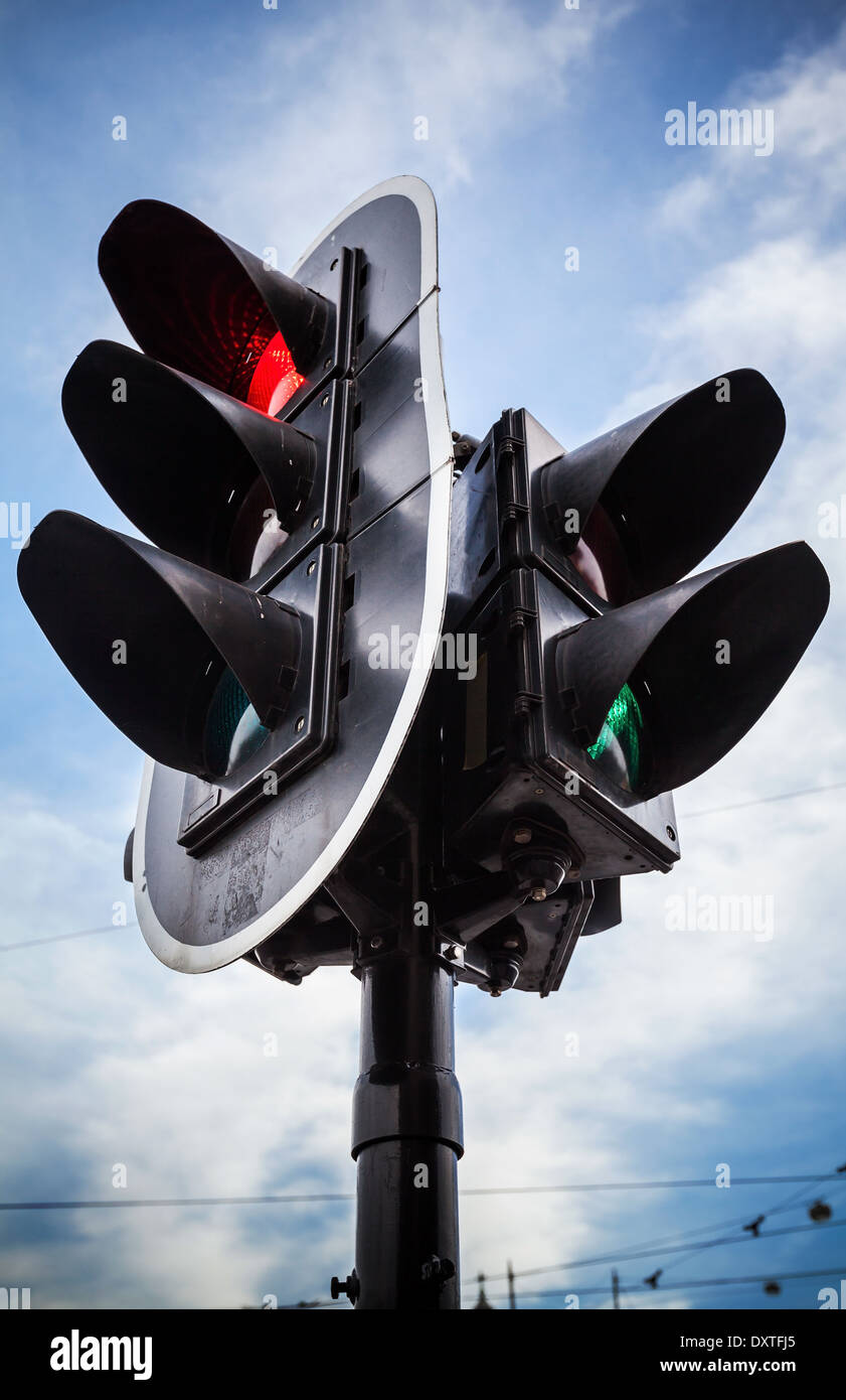 Red stop signal for cars and green pedestrian light on urban traffic ...