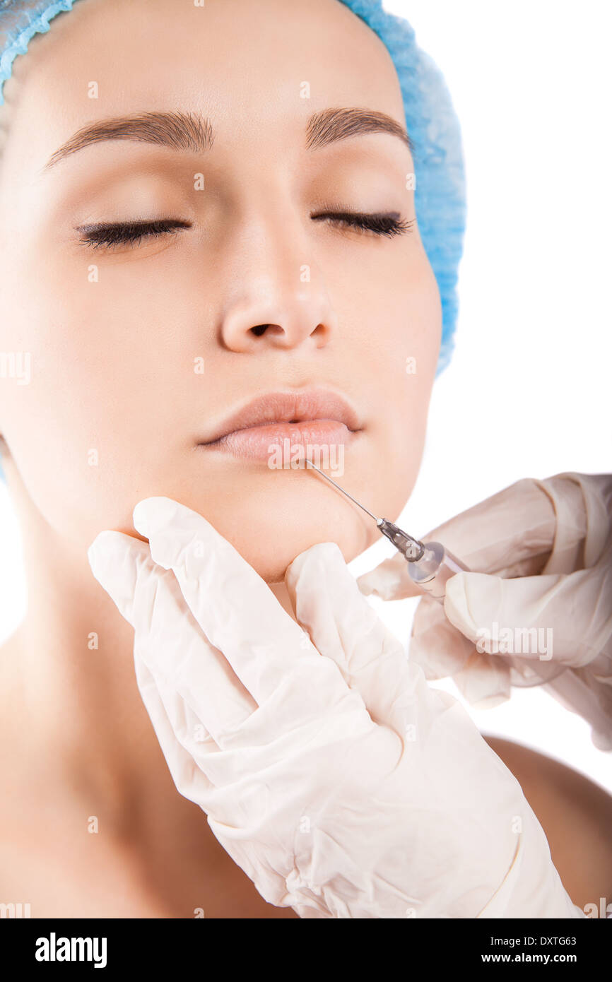 Cosmetic injection to the pretty woman face isolated over white Stock ...
