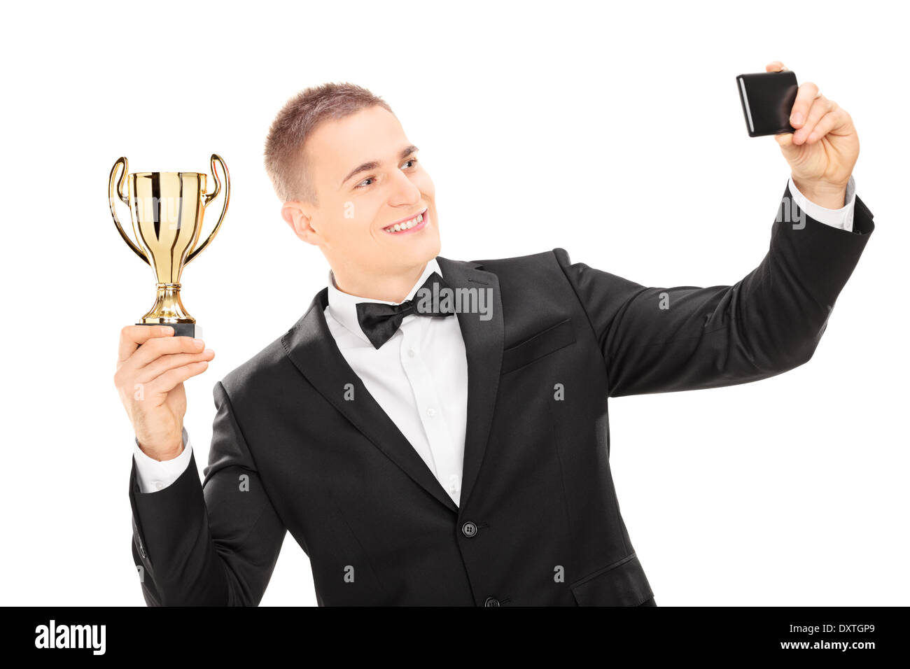 Elegant male holding a trophy and taking a selfie with phone Stock ...