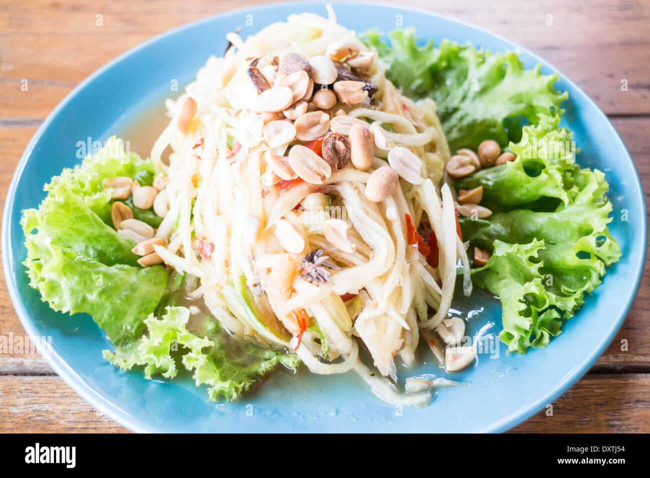 Spicy papaya salad serving on wood table, stock photo Stock Photo - Alamy