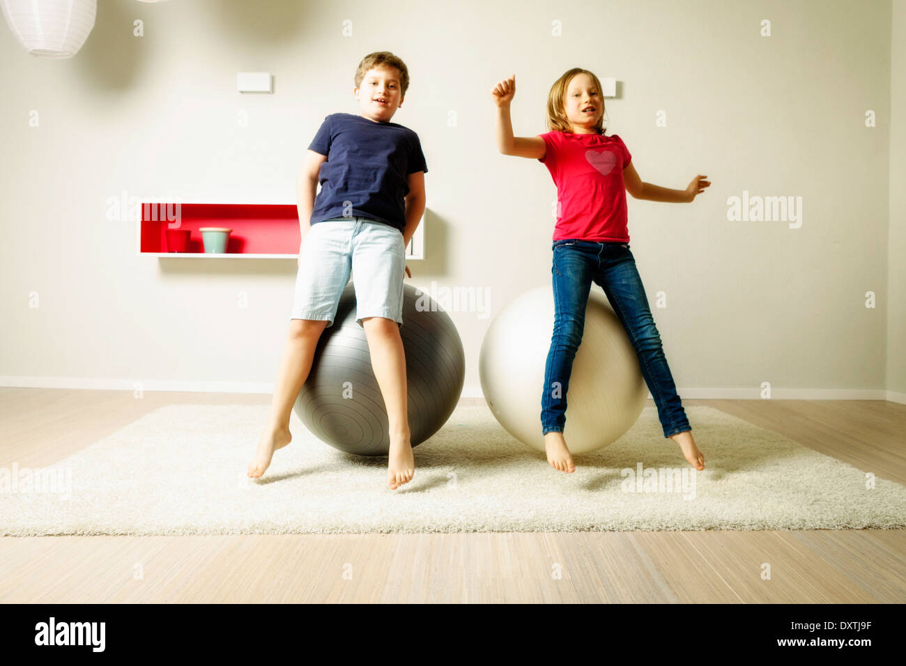 Children in living room playing with bouncing balls, Munich, Bavaria ...