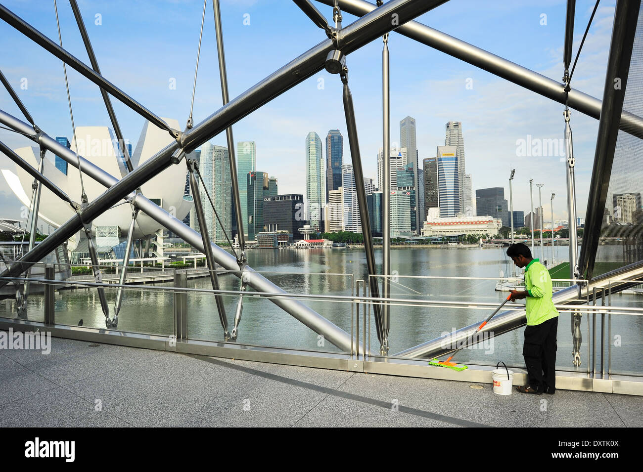 Worker cleaning the Helix bridge in front of Singapore downtown Stock ...