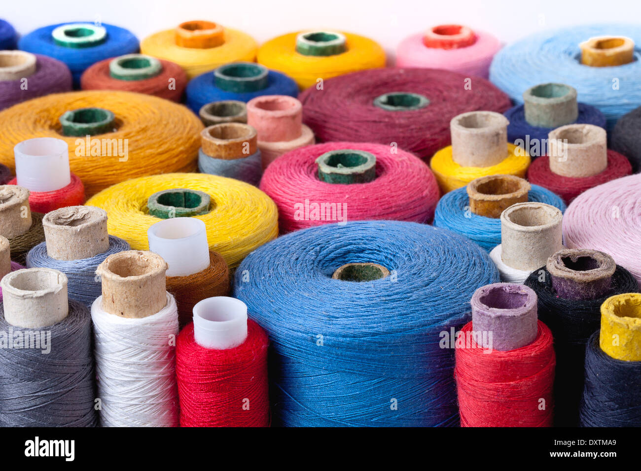 landscape close up of spools of thread of different size, texture and ...