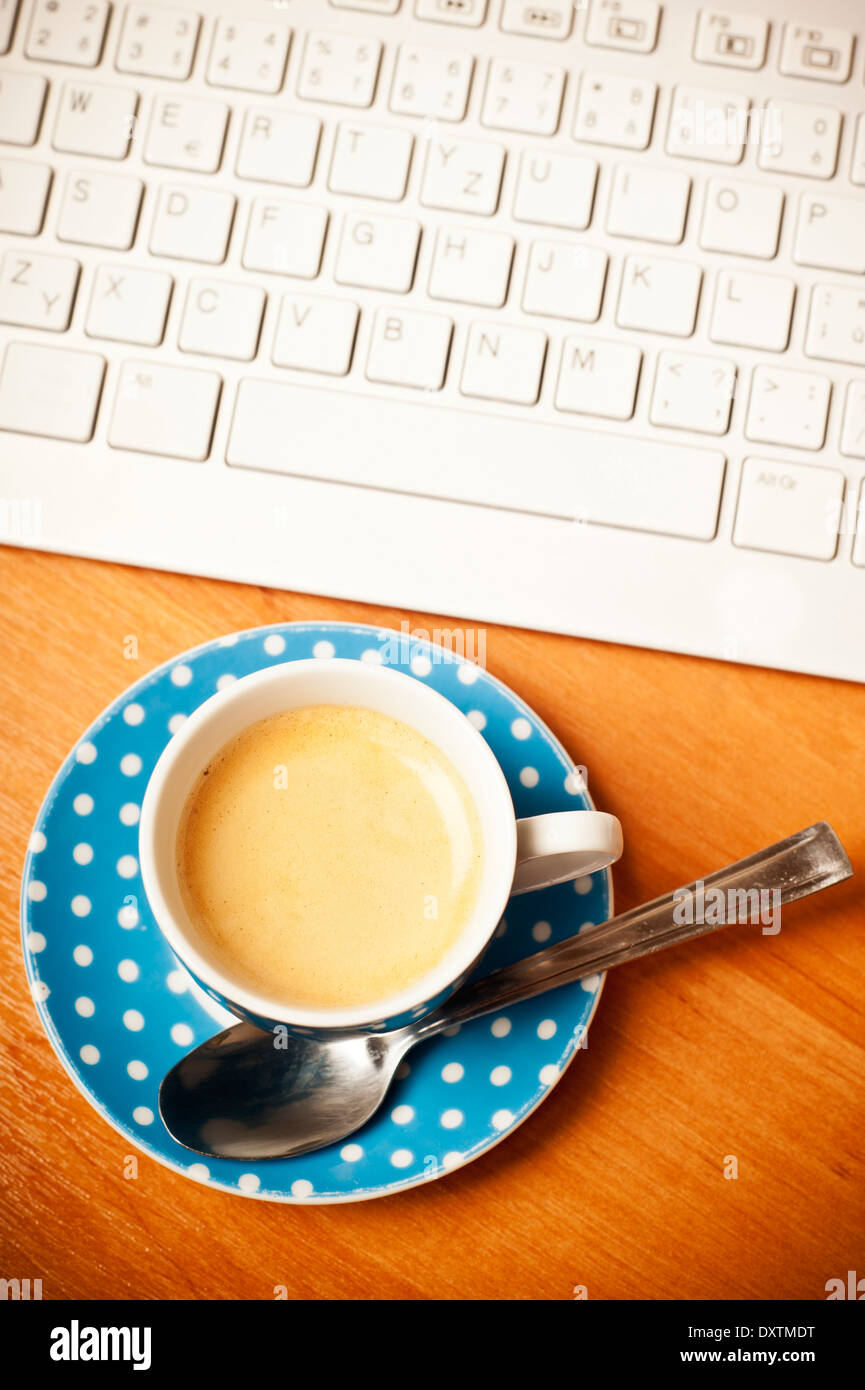 coffee cup and computer keyboard on desk, top view Stock Photo - Alamy
