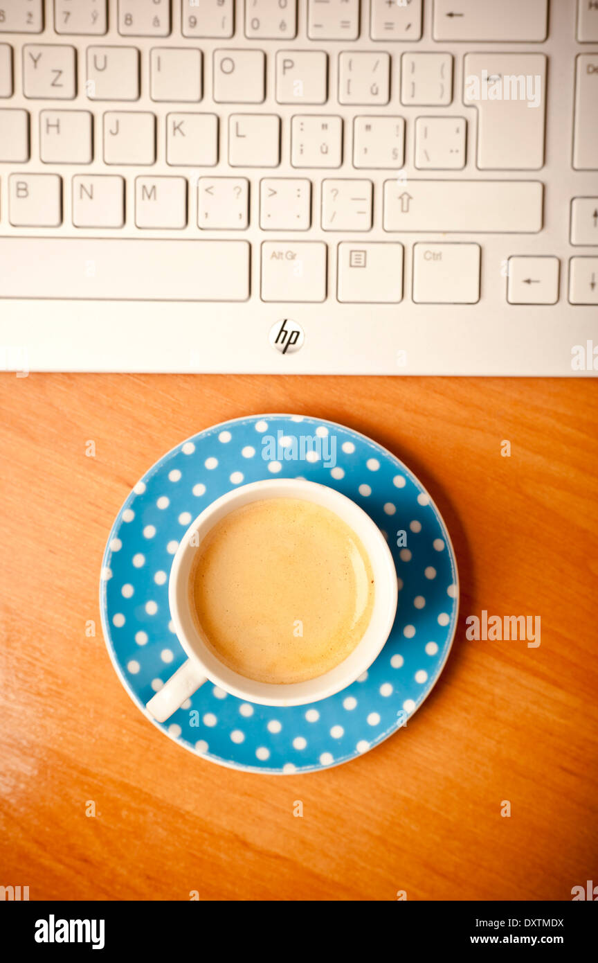 coffee cup and computer keyboard on desk, top view Stock Photo - Alamy