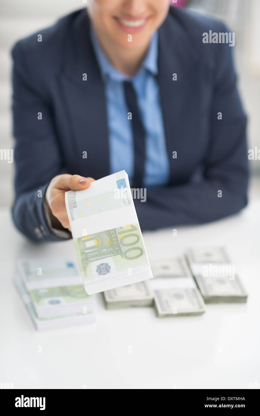 Closeup on happy business woman giving money packs Stock Photo - Alamy