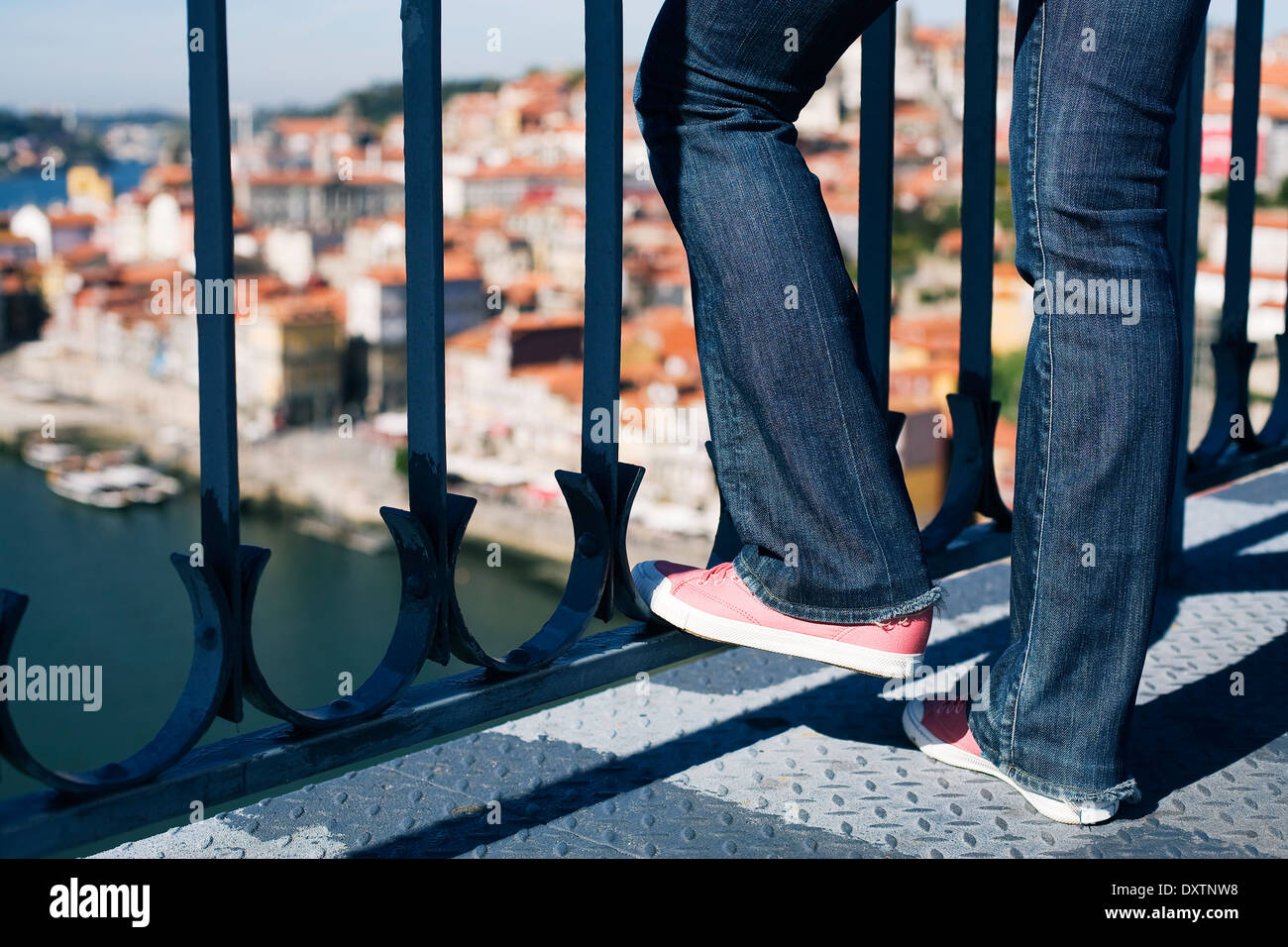 Woman leaning against railings hi-res stock photography and images - Alamy