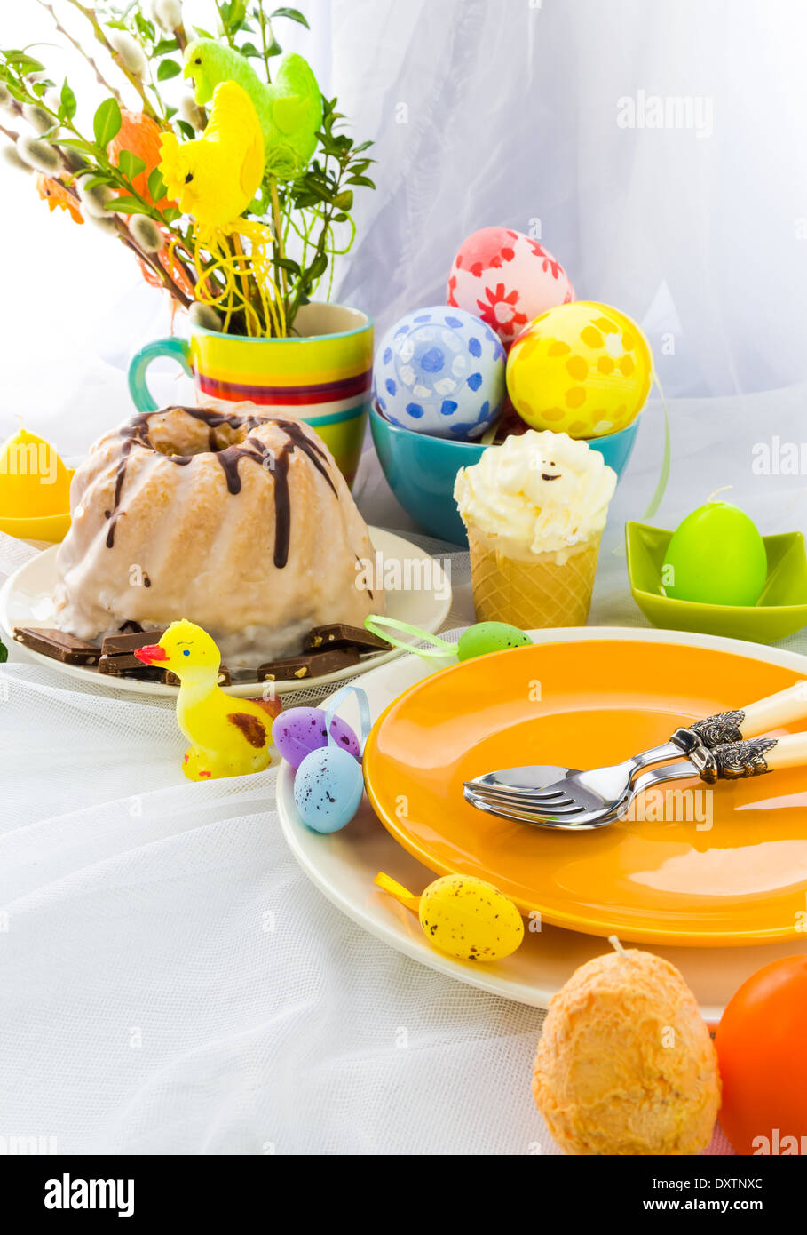 Serving Easter table with cake and eggs Stock Photo - Alamy