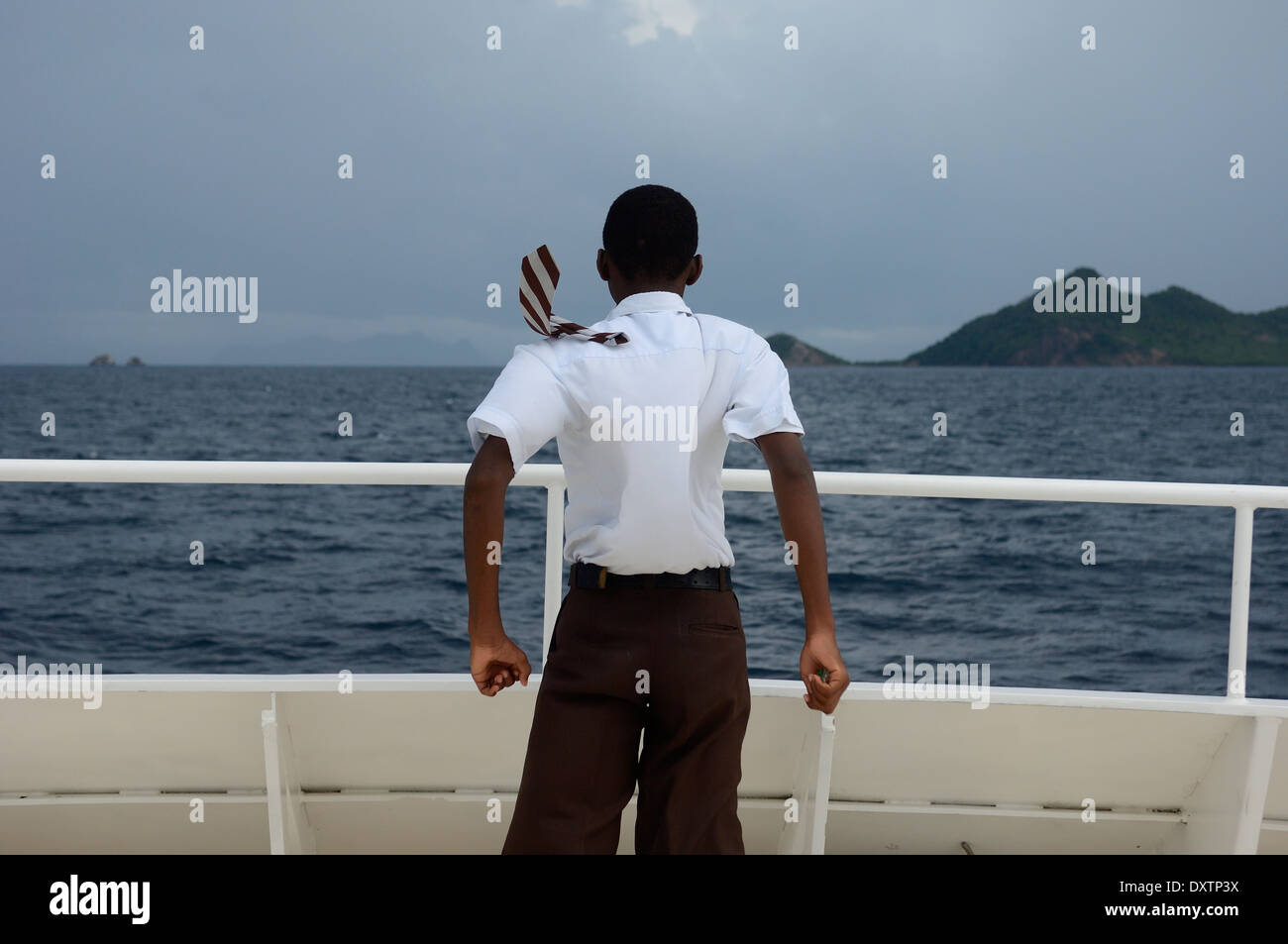 Local schoolboy on the deck of The Osprey Express ferry boat. Grenada ...