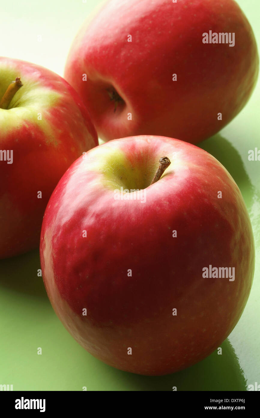 Three red apples Stock Photo - Alamy