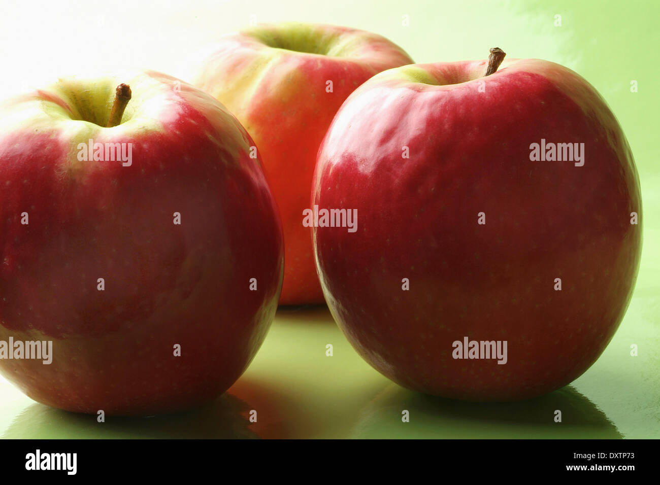 Three red apples Stock Photo - Alamy