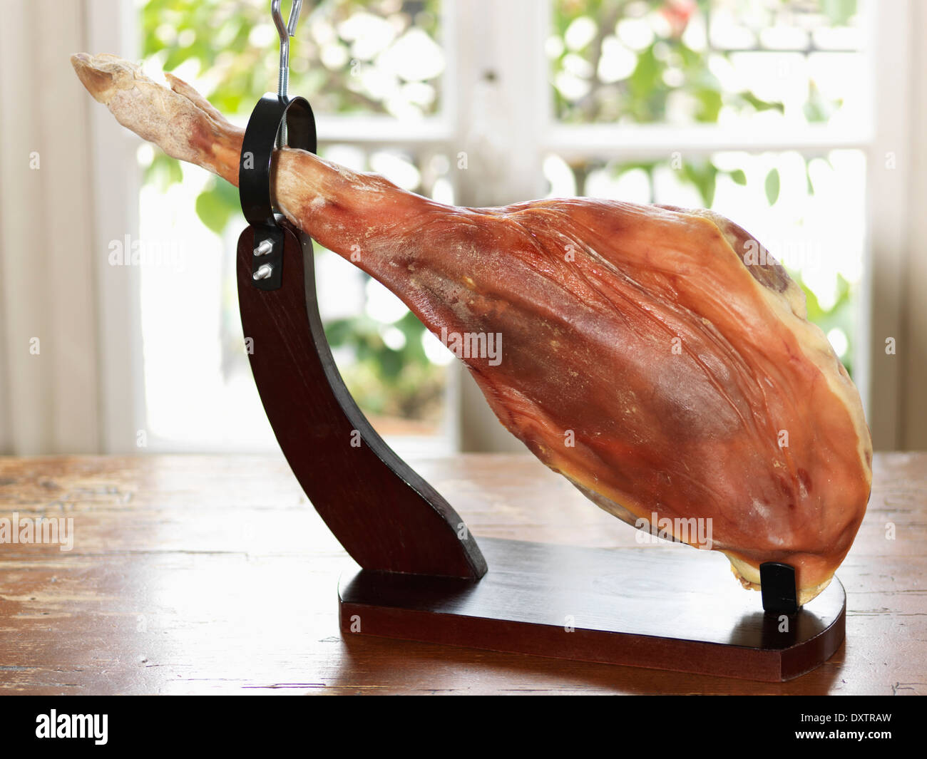Serrano ham on a carving stand Stock Photo - Alamy