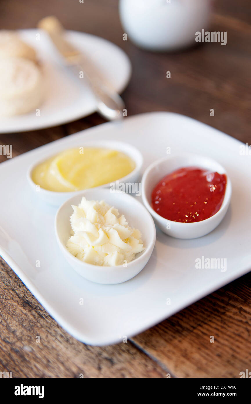 Small bowls of lemon curd,summer fruit jam and butter Stock Photo - Alamy