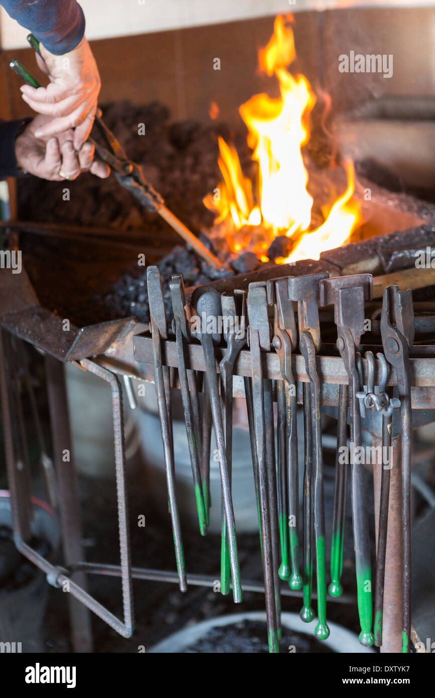 A blacksmith working at an old iron forge Stock Photo - Alamy