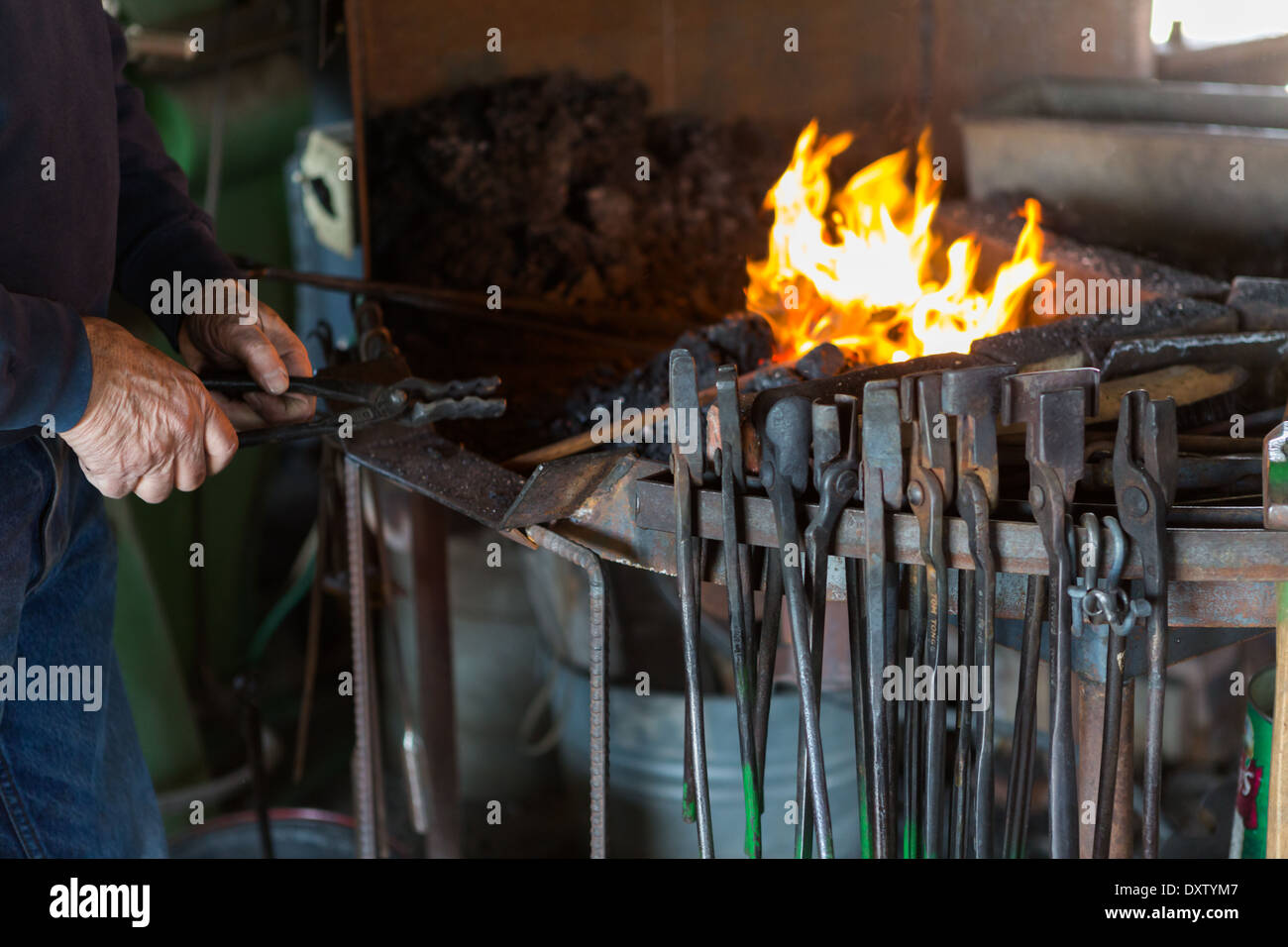 A blacksmith working at an old iron forge Stock Photo - Alamy