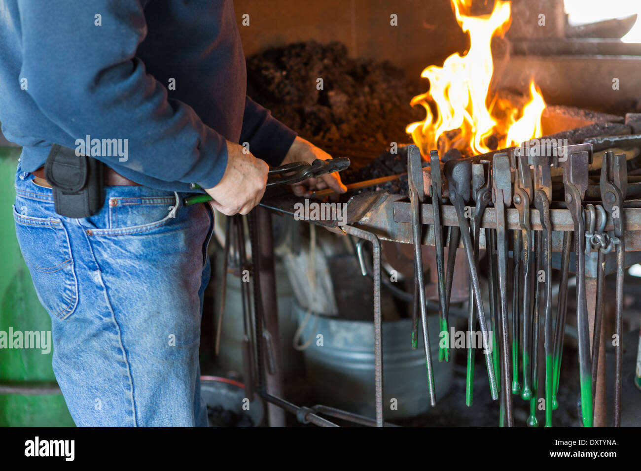 A blacksmith working at an old iron forge Stock Photo - Alamy