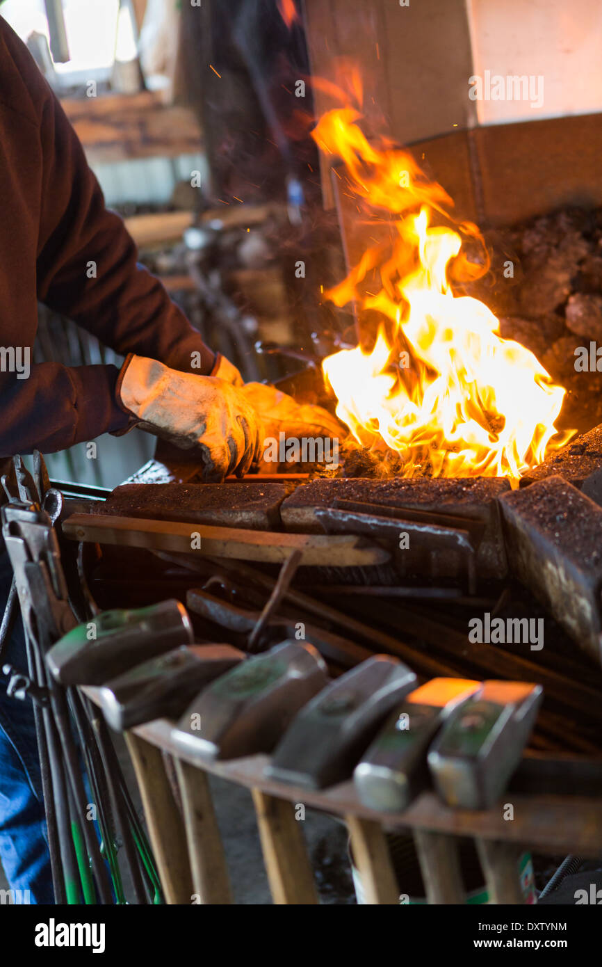A blacksmith working at an old iron forge Stock Photo - Alamy