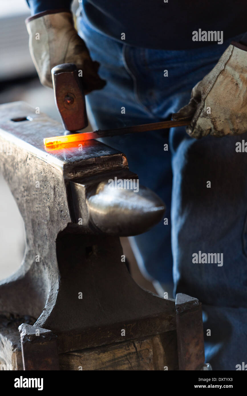 A blacksmith forging hot iron on the anvil Stock Photo - Alamy