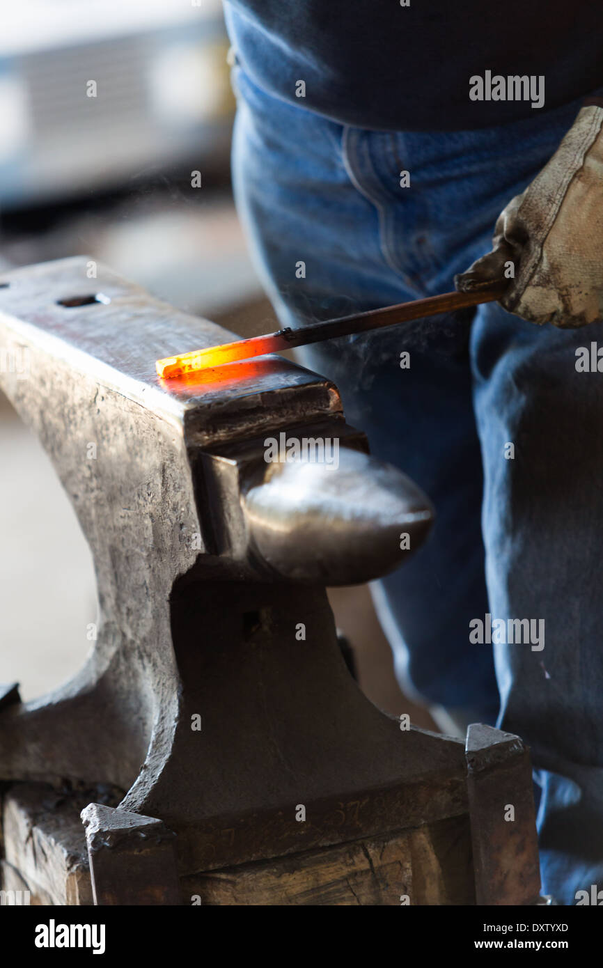 A blacksmith forging hot iron on the anvil Stock Photo - Alamy
