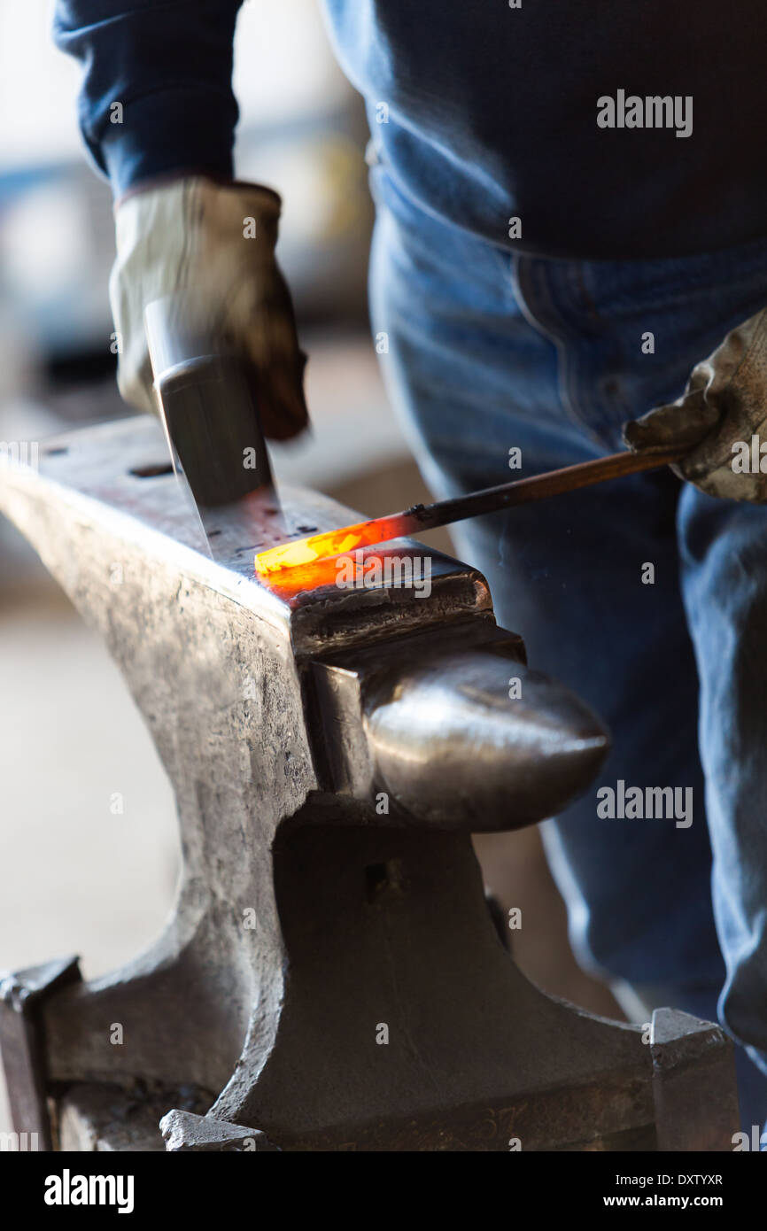 A blacksmith forging hot iron on the anvil Stock Photo - Alamy