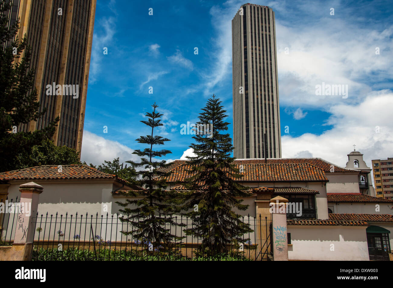 A white colonial church with two skyscrapers rising behind it Stock ...