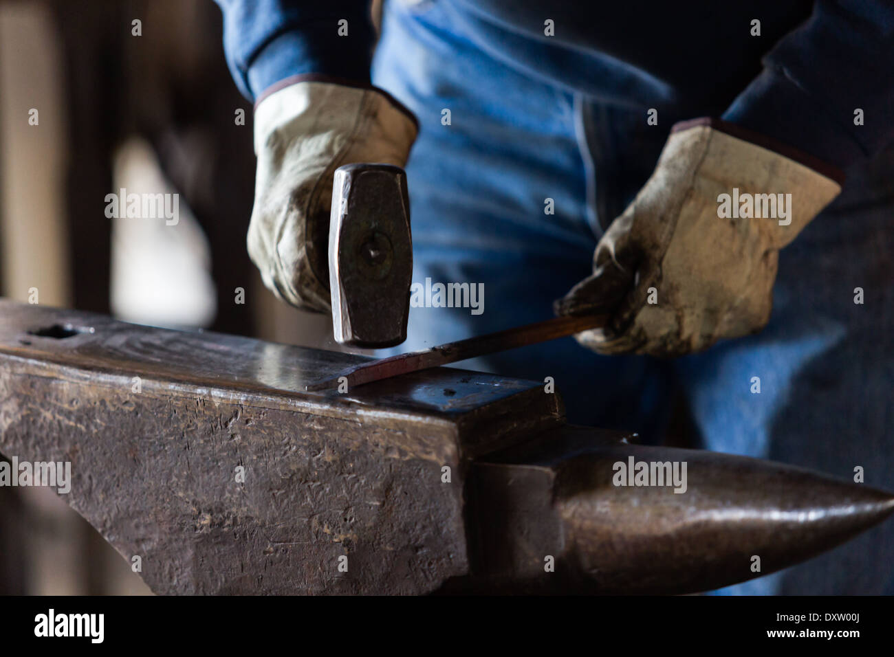 A blacksmith forging hot iron on the anvil Stock Photo - Alamy