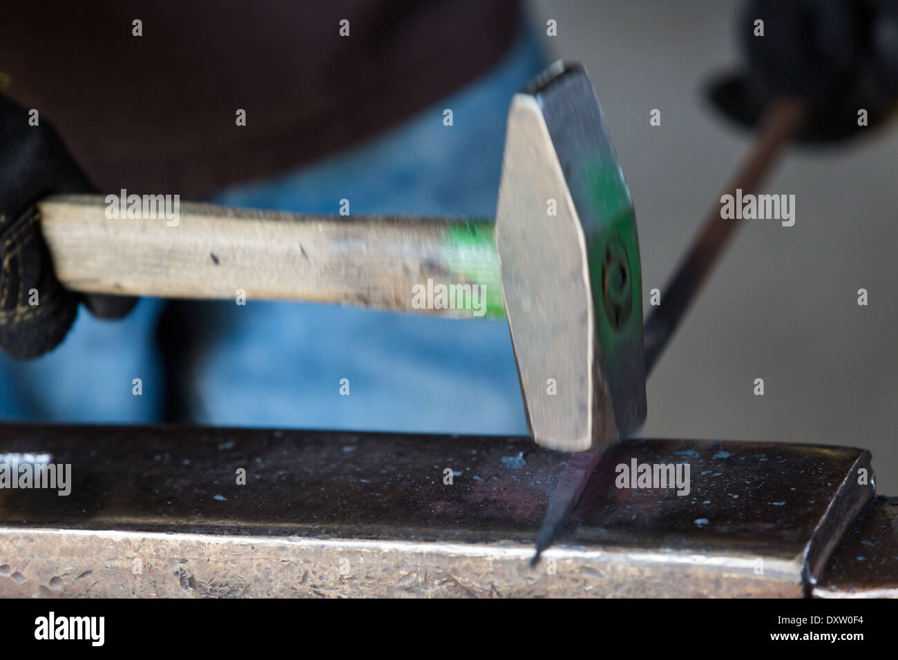 A blacksmith forging hot iron on the anvil Stock Photo - Alamy