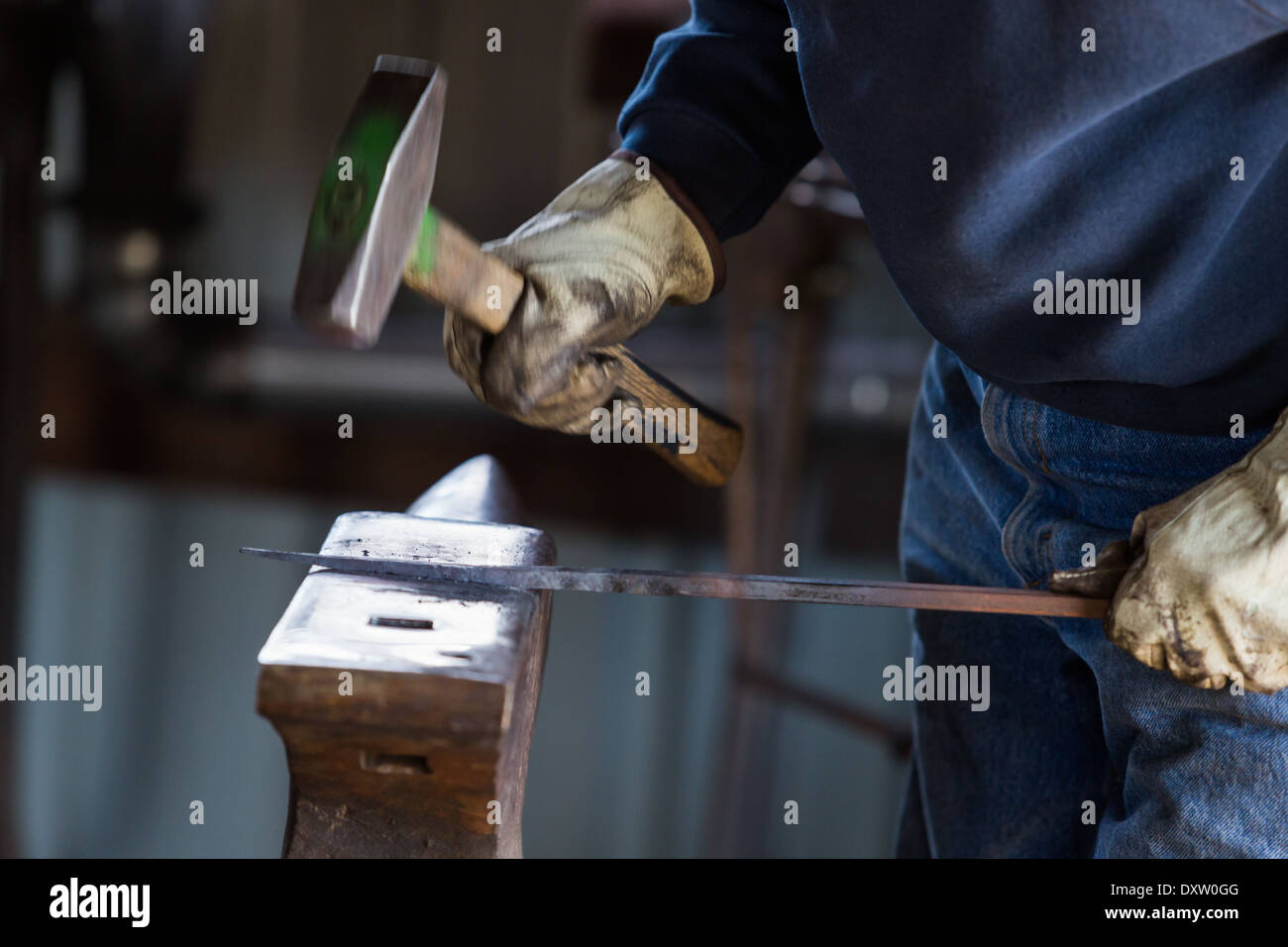 A blacksmith forging hot iron on the anvil Stock Photo - Alamy