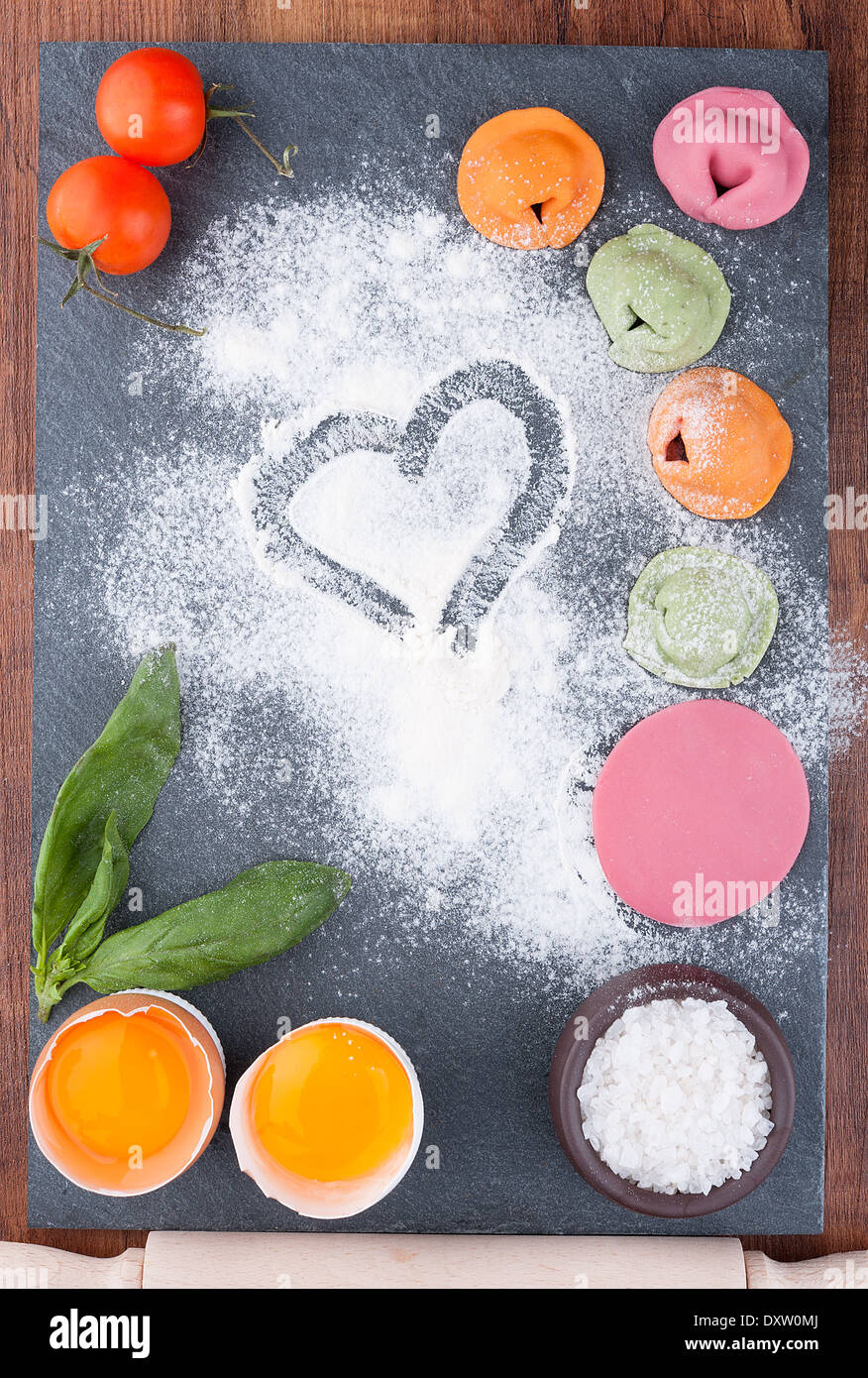 Homemade multicolor ravioli with vegetables on a slate blackboard Stock ...