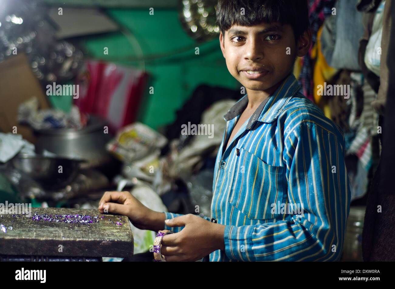 Kid working in bangles manufacture, Kolkata Stock Photo - Alamy