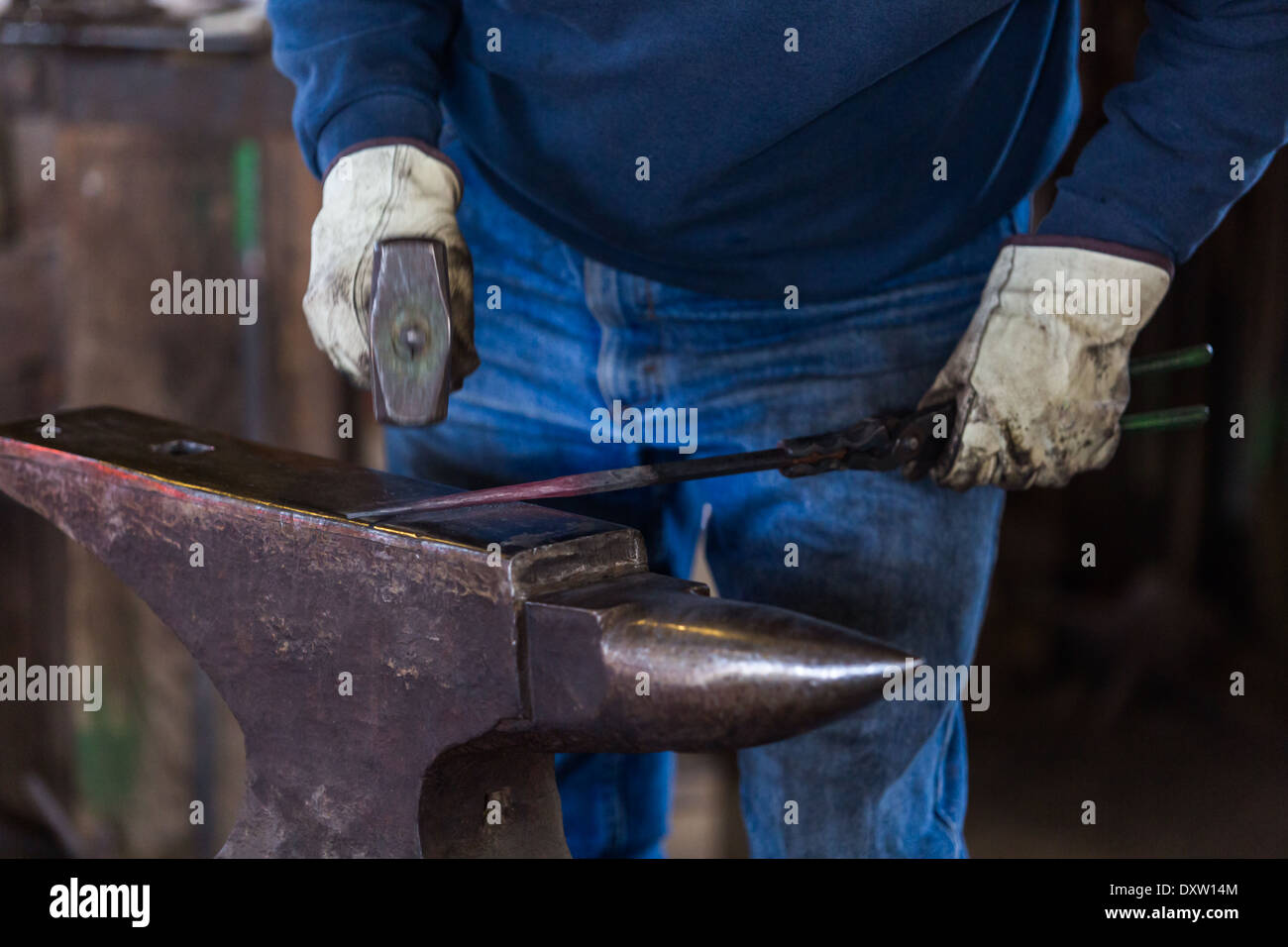 A blacksmith forging hot iron on the anvil Stock Photo - Alamy