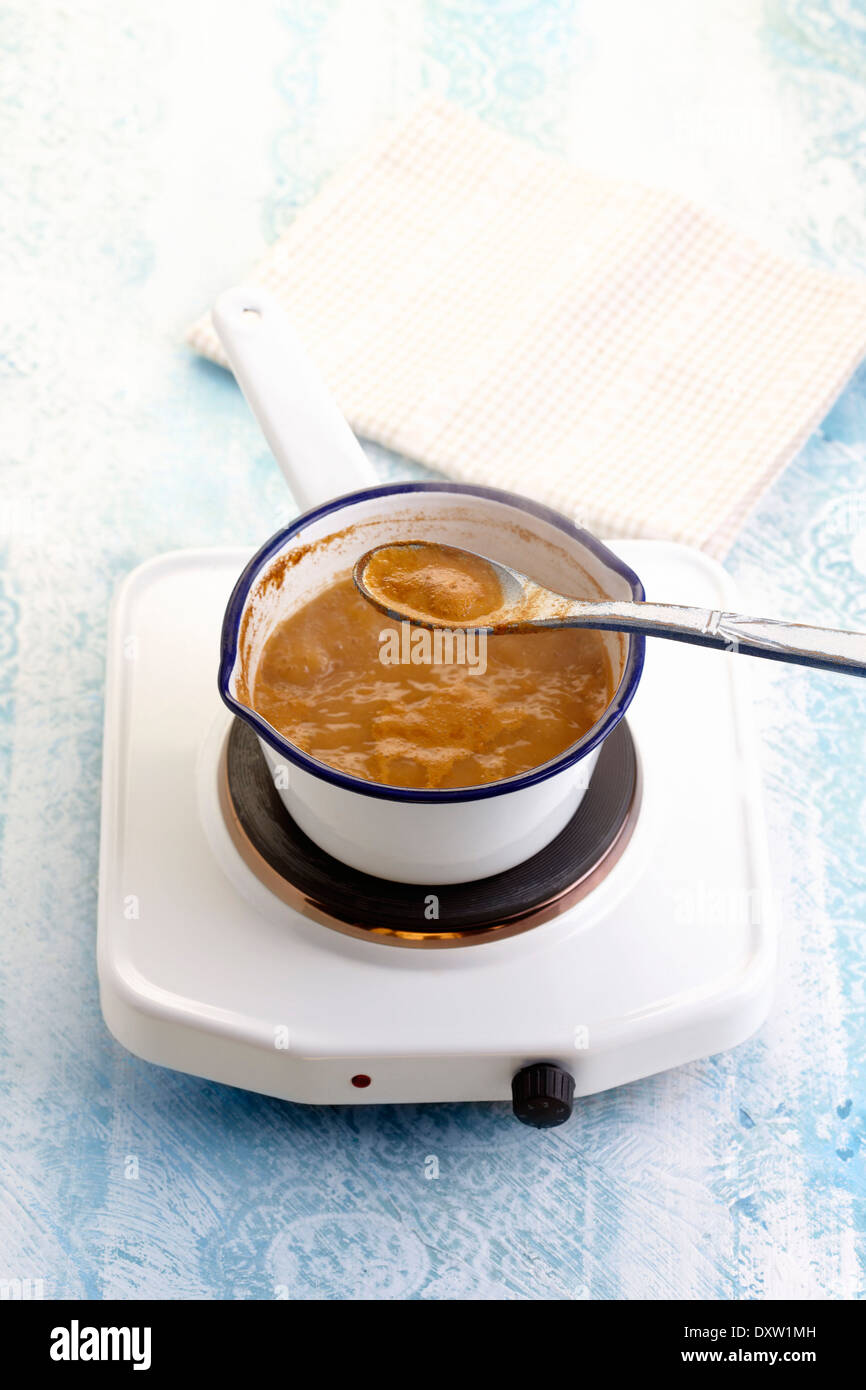 Skimming the soup Stock Photo - Alamy