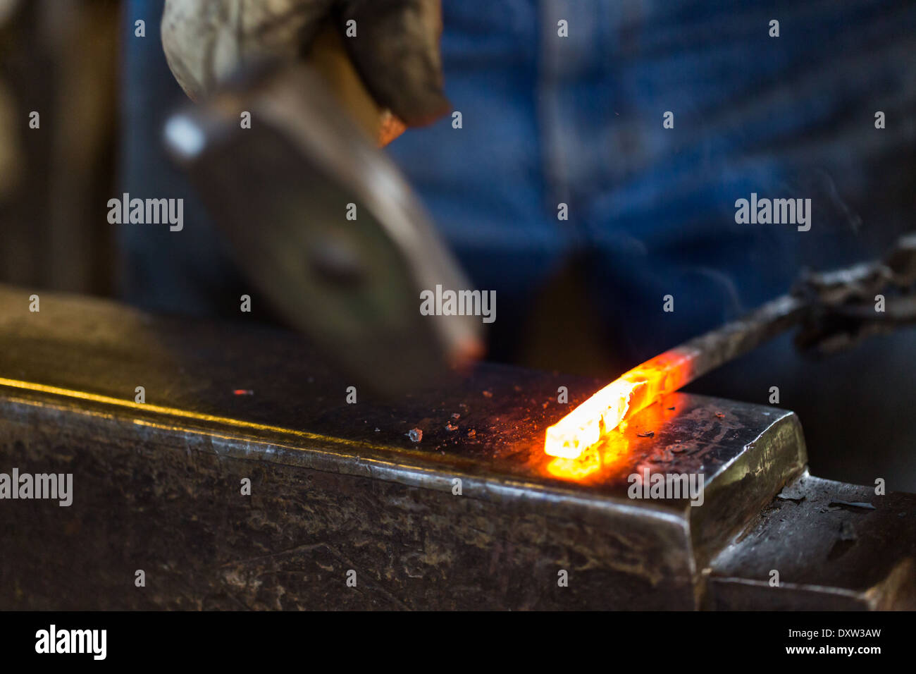 A blacksmith forging hot iron on the anvil Stock Photo - Alamy