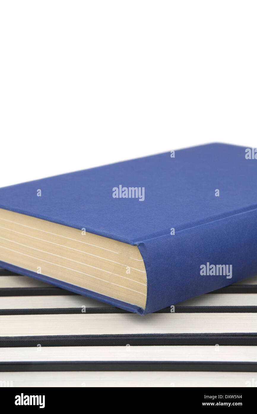 Group of books in a row and one book standing out from others with ...