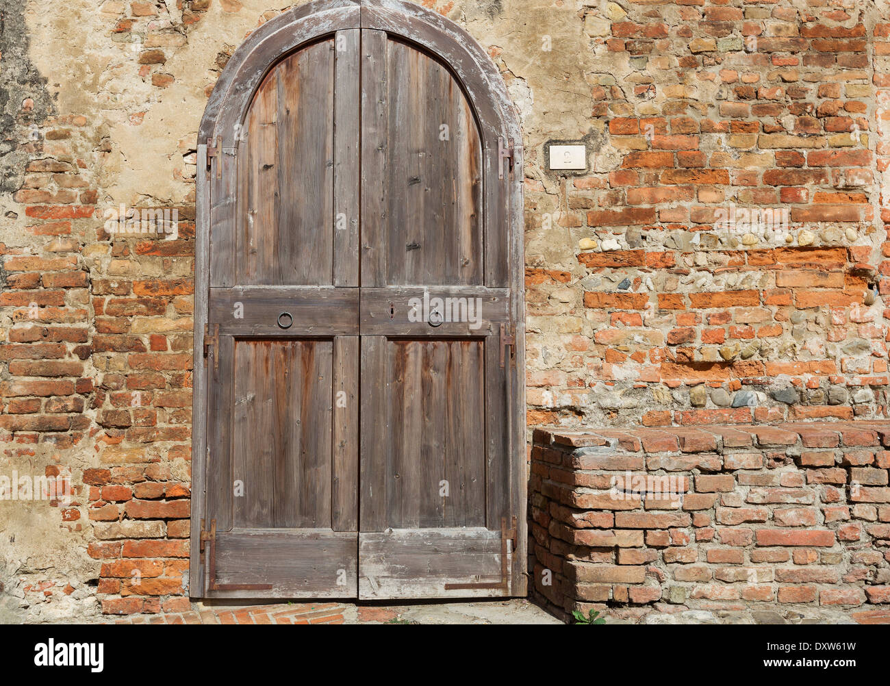 Wooden rounded door, facade, Tuscany medieval town Certaldo Alto, Italy ...