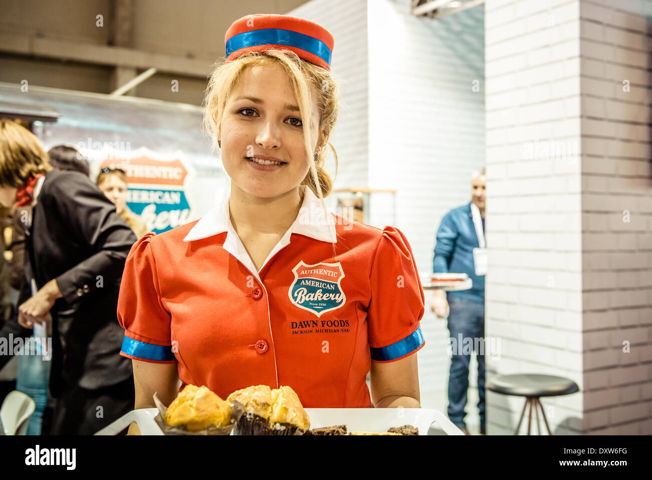 Barcelona, Spain. March 31st, 2014: A hostess hands out brownies from ...