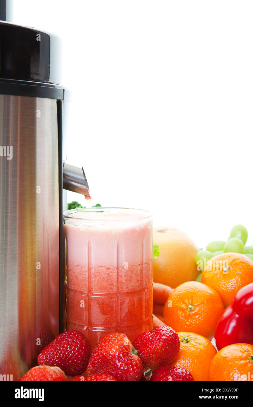 A glass of freshly squeezed juice under a still dripping spout. Shot on ...