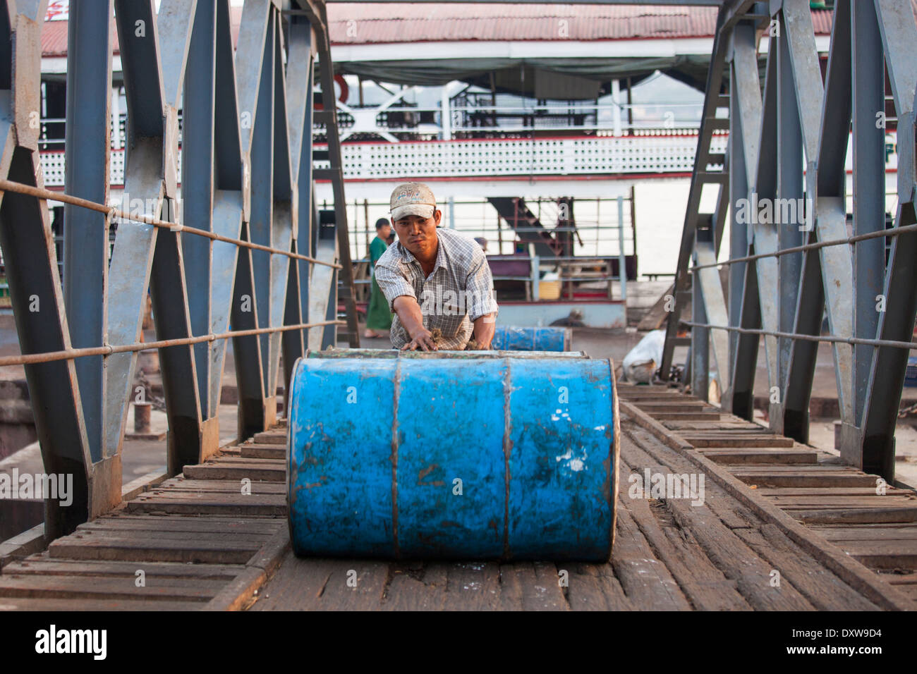 Pushing an empty fuel barrel at the port in Yangon, Myanmar Stock Photo ...