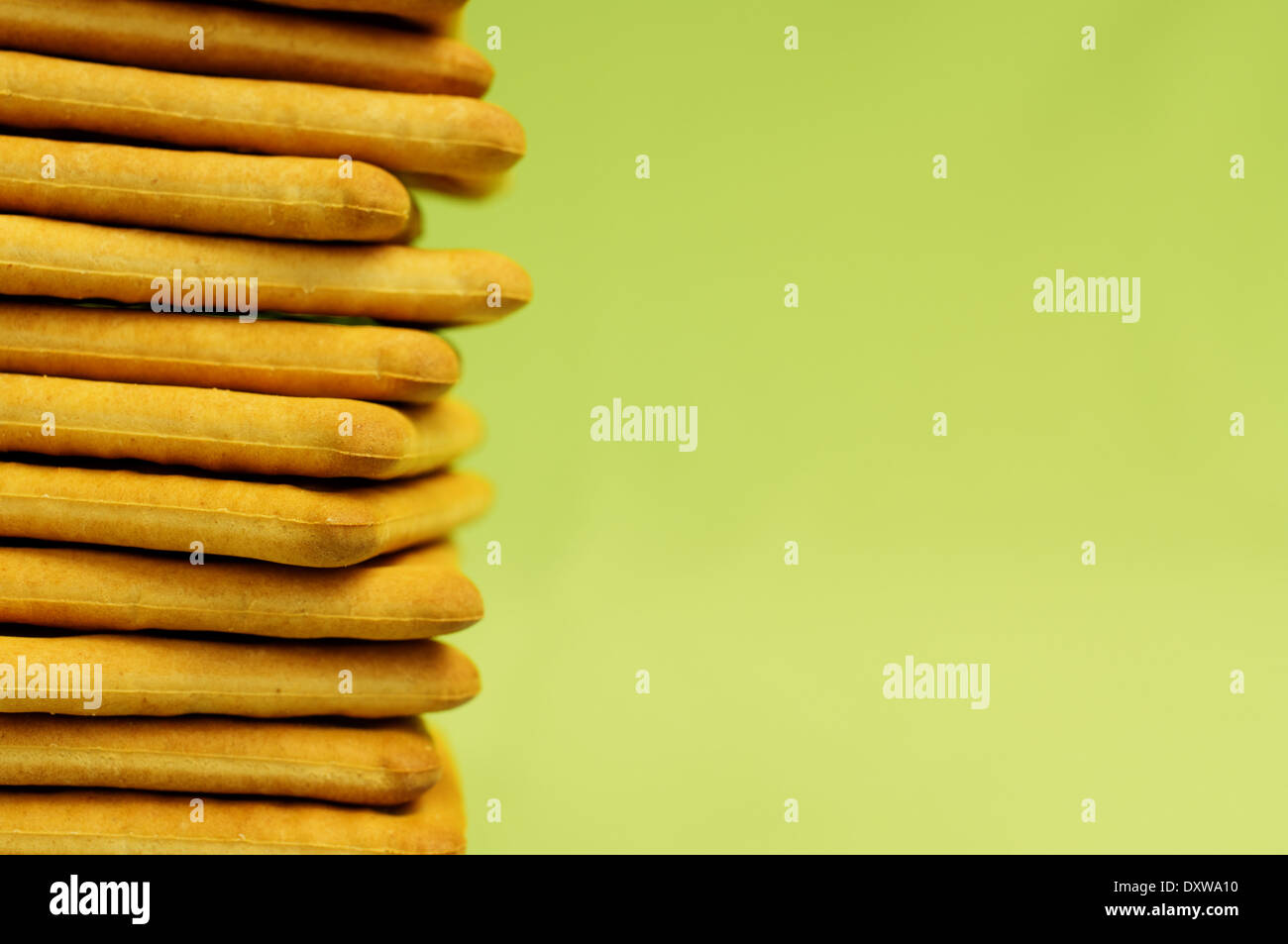 Crackers stacked. Stack of crackers on the left, the green background ...