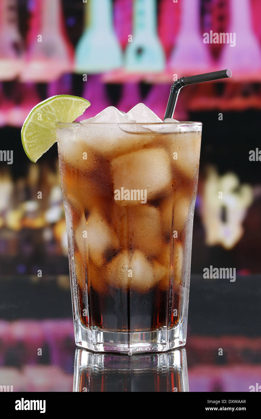 Cold cola drink in glass with ice cubes in a bar or a party Stock Photo ...